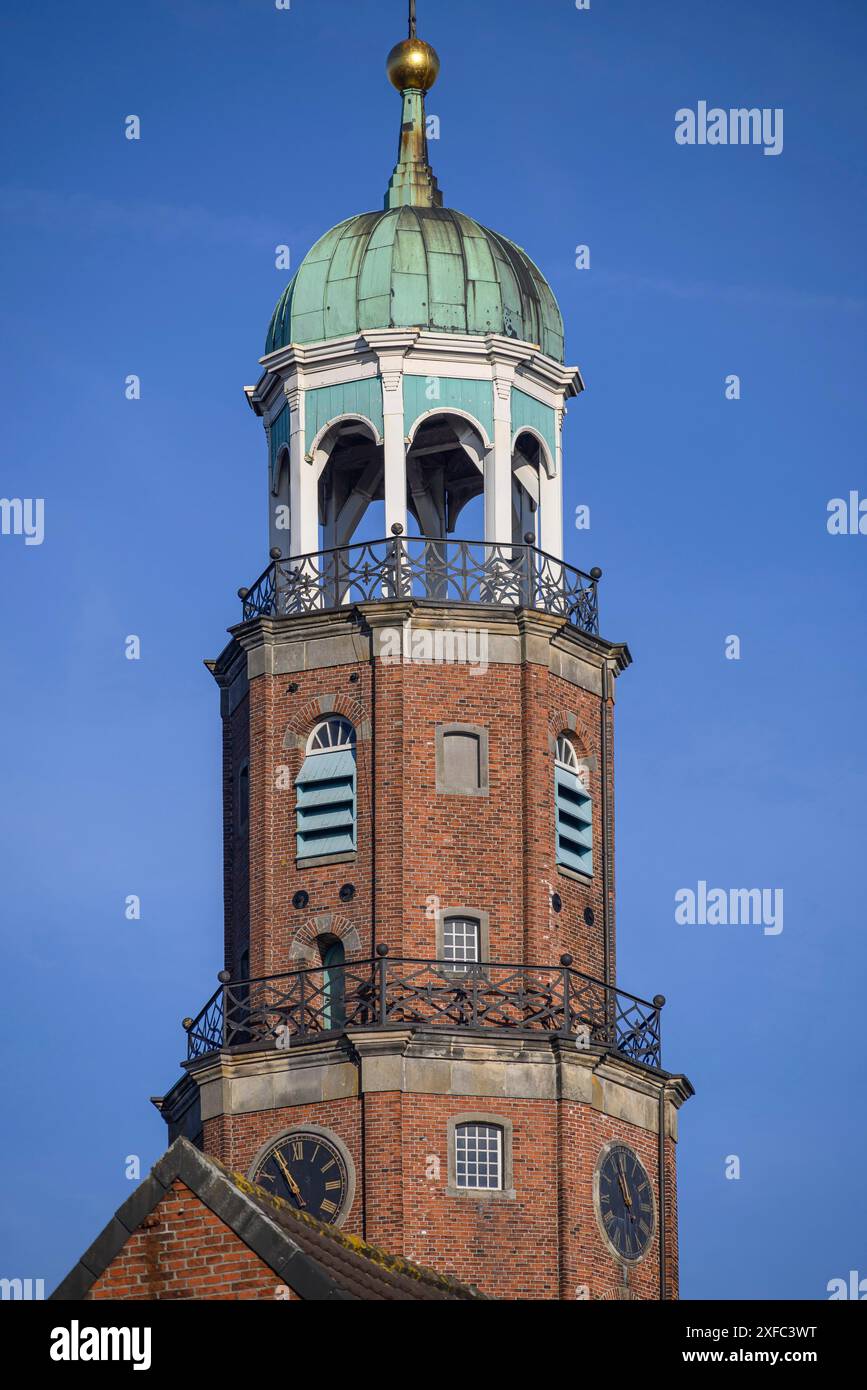 Historic bell tower with green dome and clock, towering into the blue ...