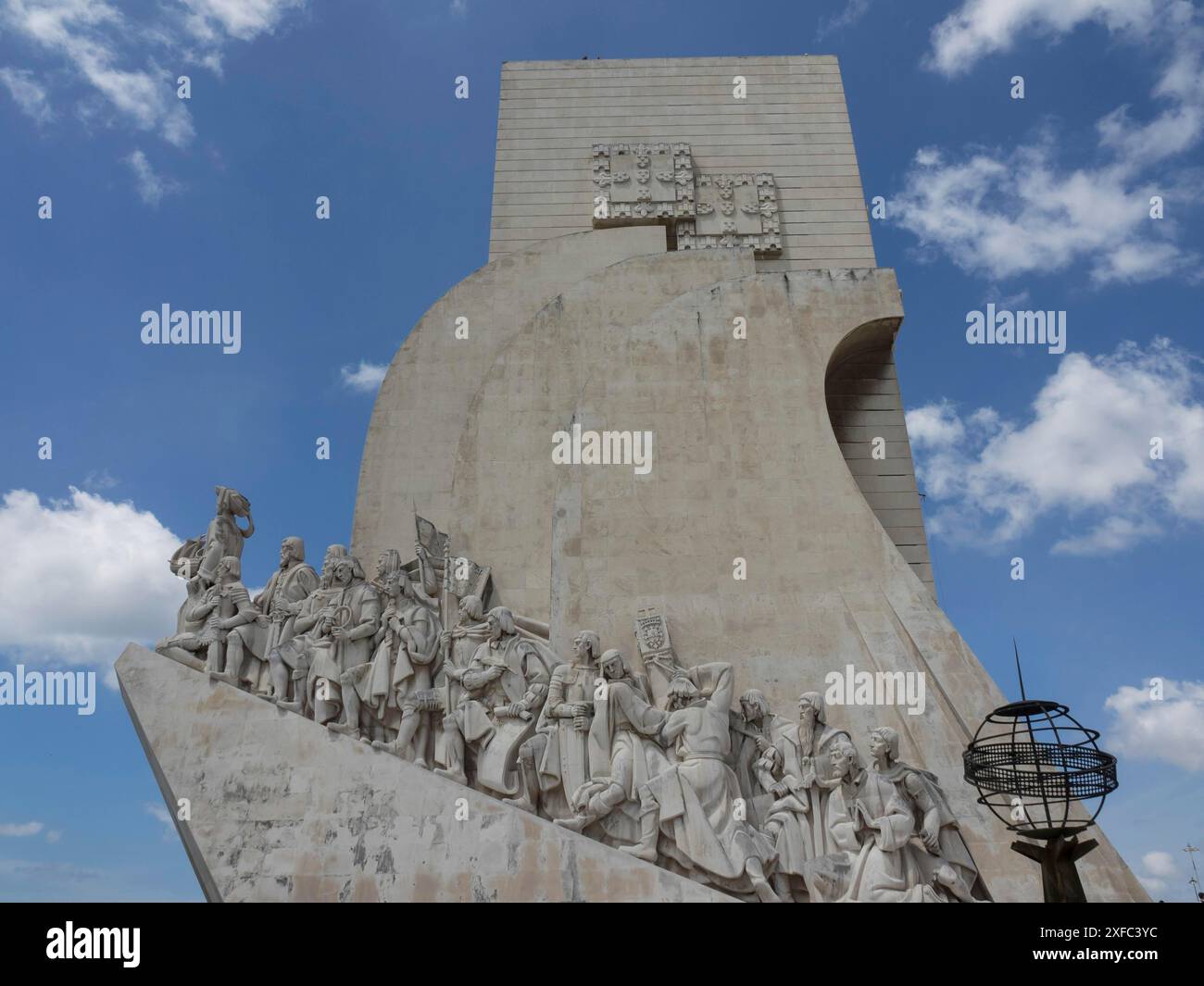 A monument with historical figures carved in stone under a blue sky ...