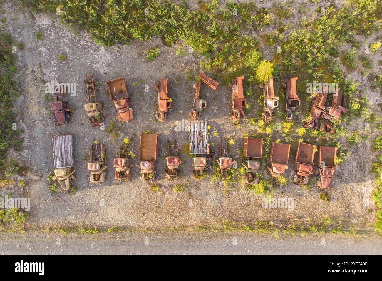 Array of vintage, rusty Ford trucks dumped along the side of the North ...