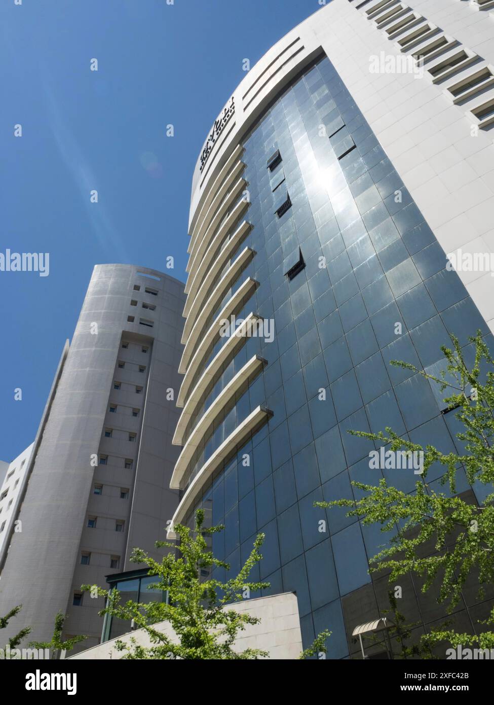 Tall modern building with glass facade under a clear blue sky, lisbon ...