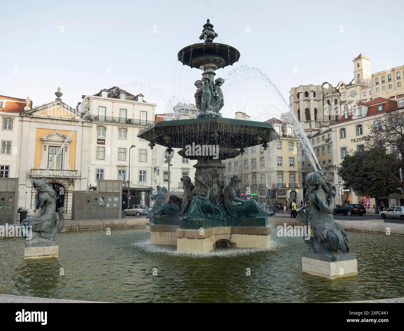 Historic fountain in a square surrounded by buildings, water gushing ...