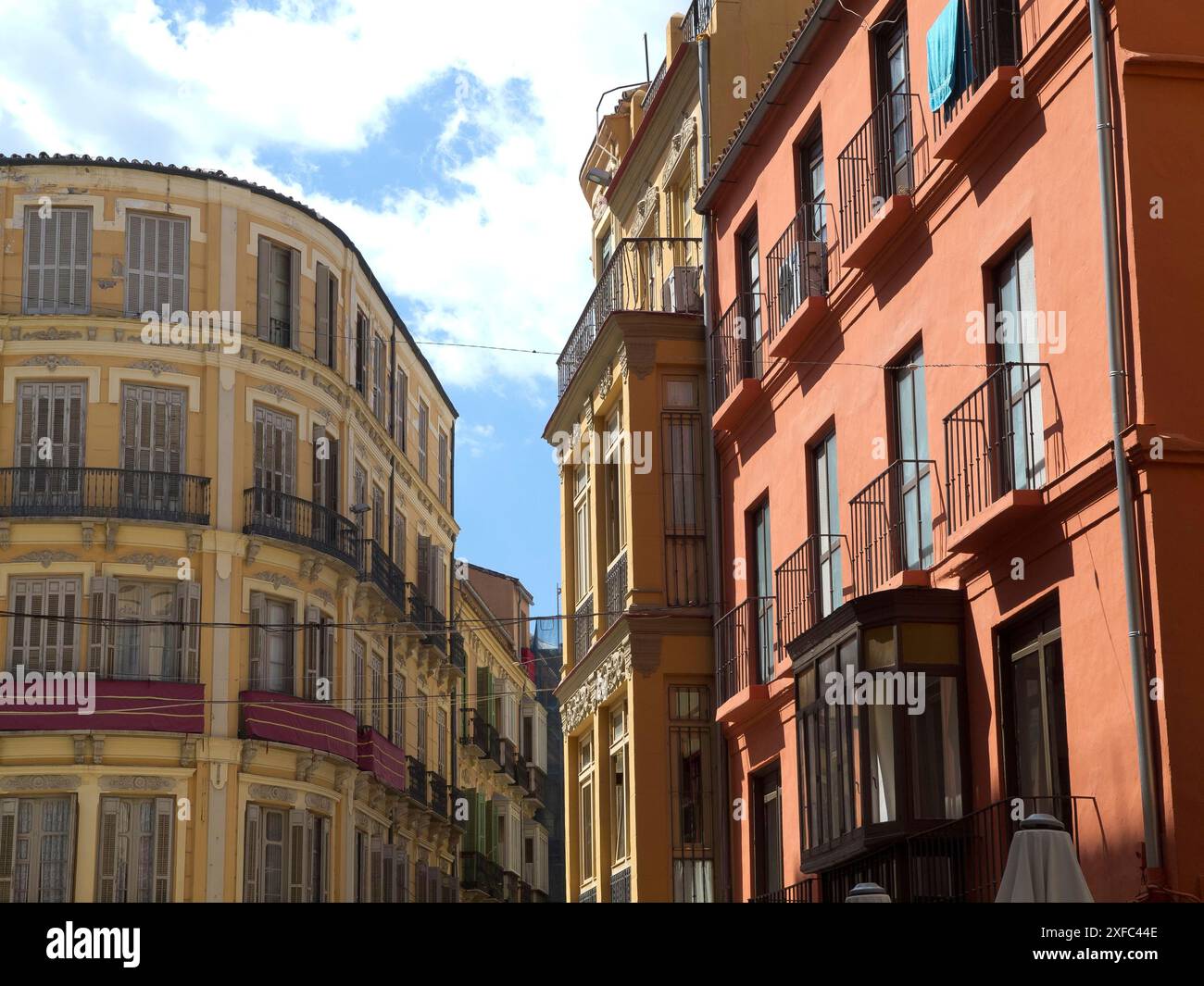 Row of colourful buildings in an urban environment, with balconies and ...