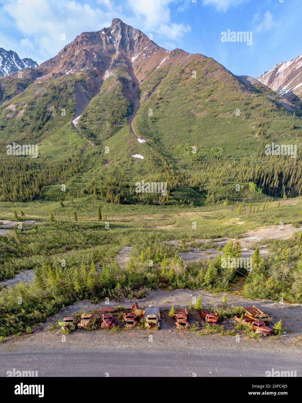Array of vintage, rusty Ford trucks dumped along the side of the North ...
