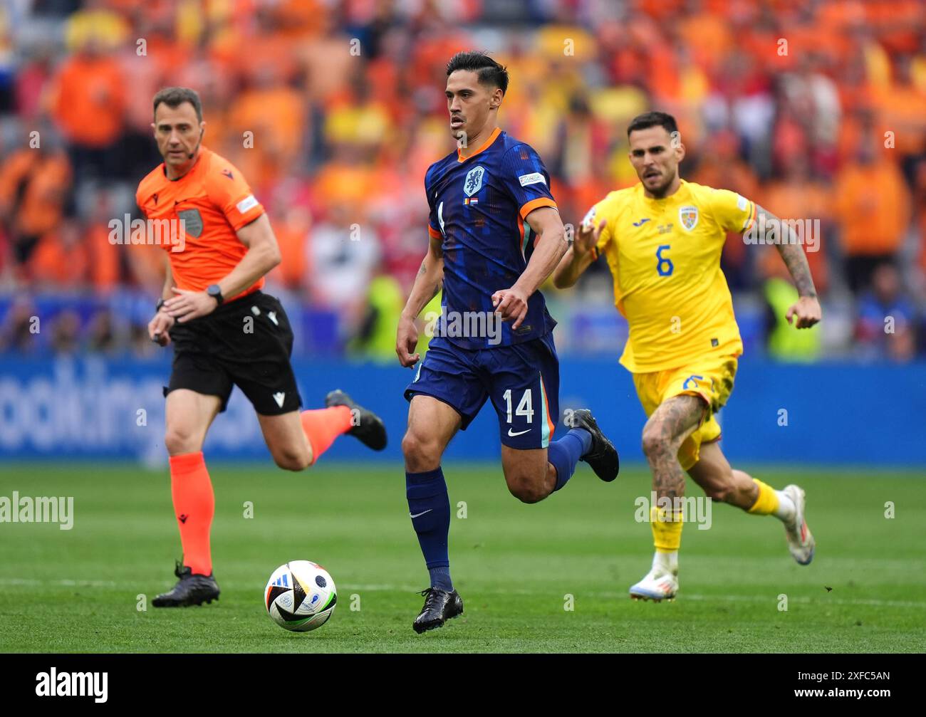 Netherlands's Tijjani Reijnders and Romania's Marius Marin in action ...