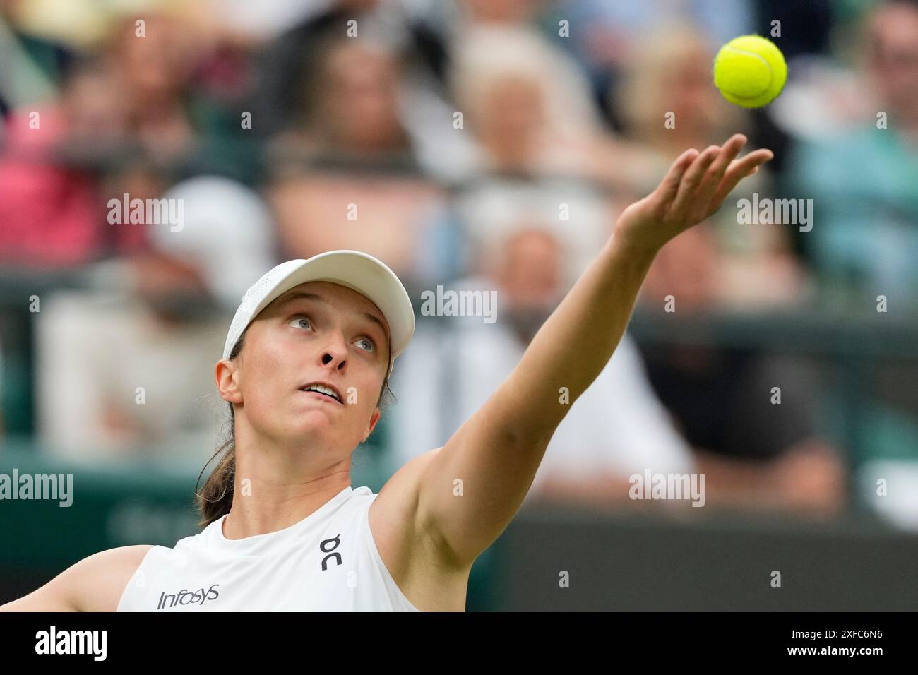 Iga Swiatek of Poland serves to Sofia Kenin of the United States during ...