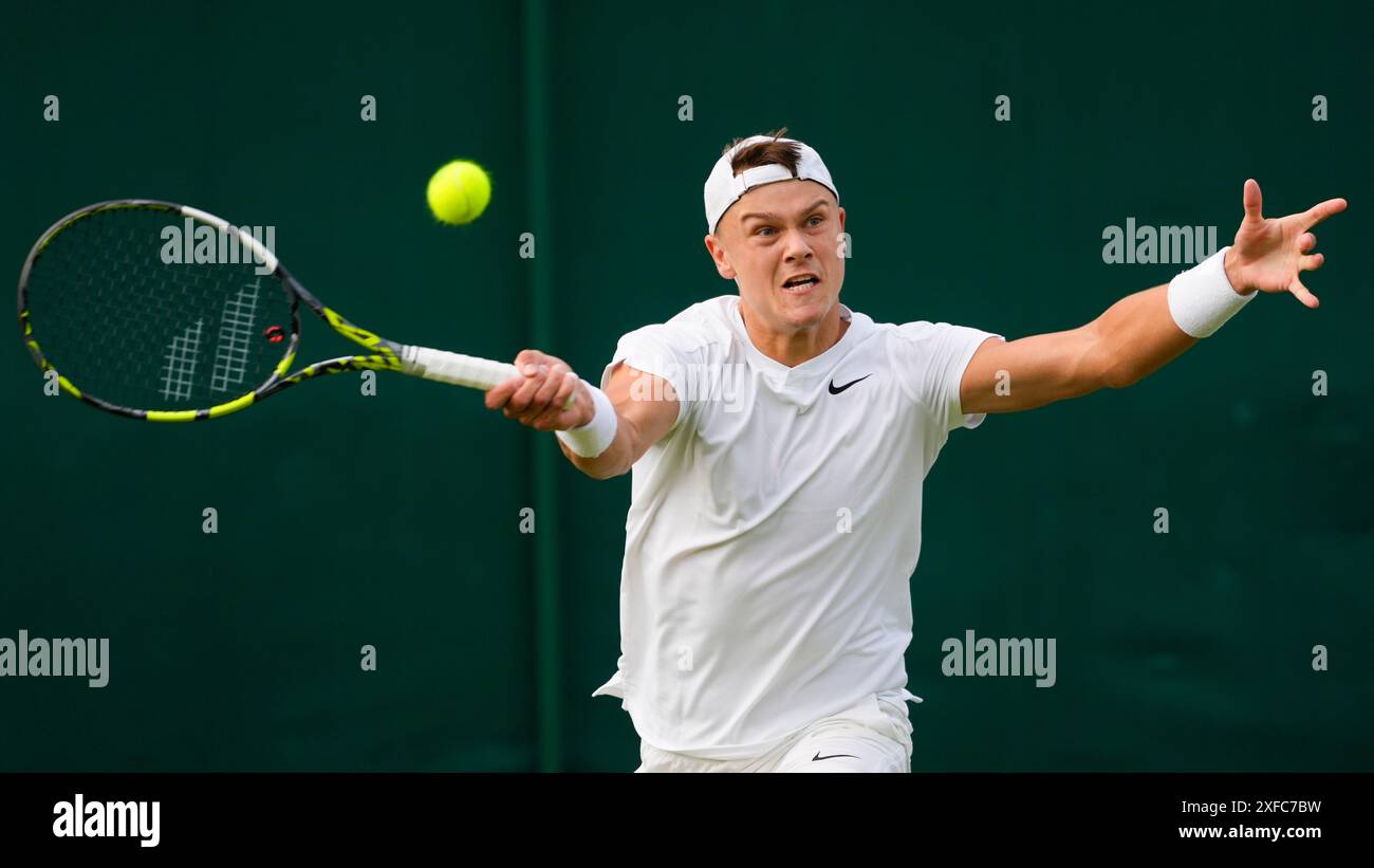 Holger Rune of Denmark plays a forehand return to Soonwoo Kwon of Korea ...