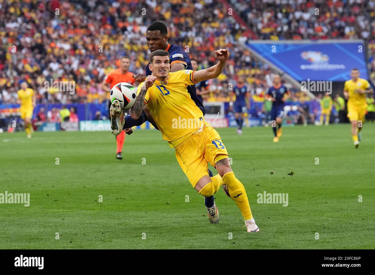 Romania's Valentin Mihaila and Netherlands's Denzel Dumfries battle for ...