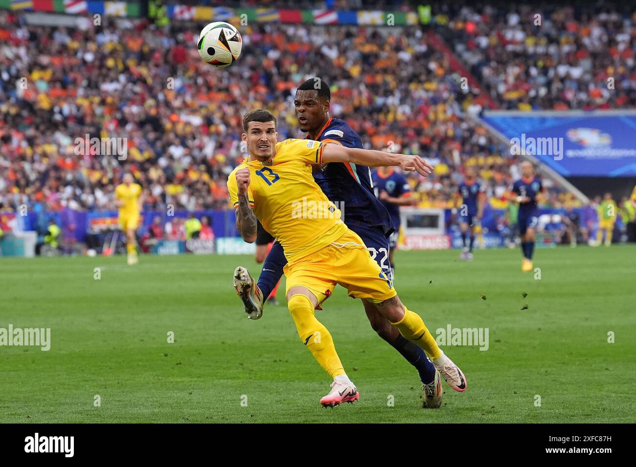 Romania's Valentin Mihaila (left) and Netherlands's Denzel Dumfries ...