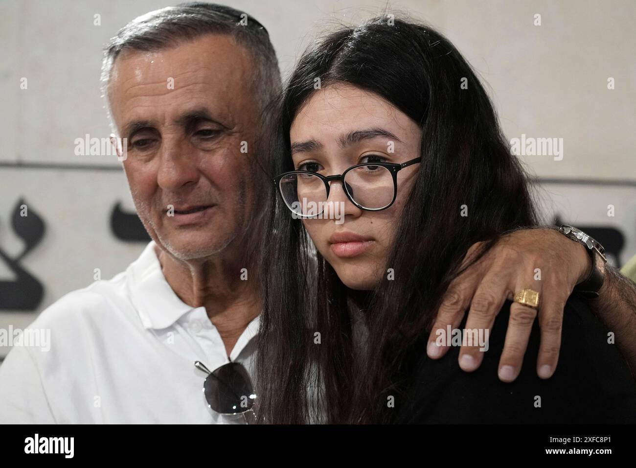 Freed Israeli hostage Noa Argamani, right, comforts her father Yakov ...