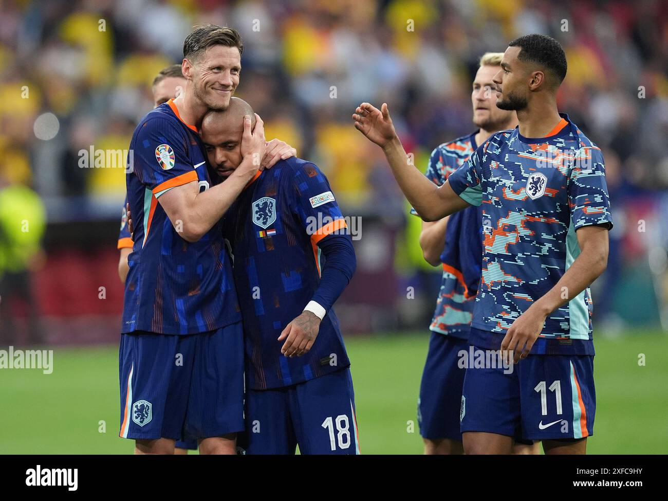 Netherlands's Wout Weghorst (left) Donyell Malen embrace after winning ...