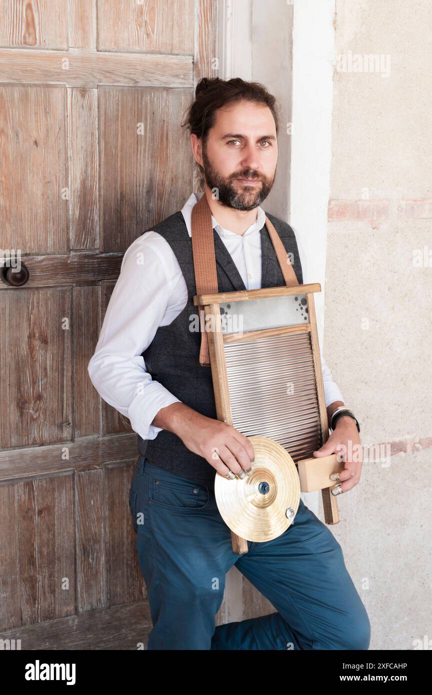 Close-up of a man playing a jazz instrument on a washboard in the ...