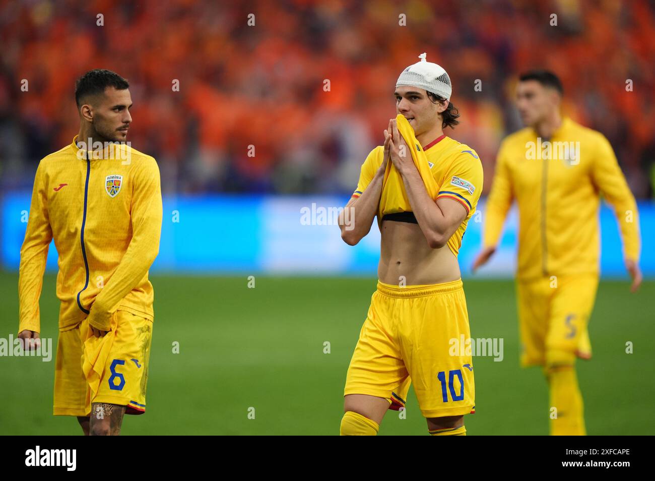 Romania's Marius Marin and Ianis Hagi dejected following the UEFA Euro ...