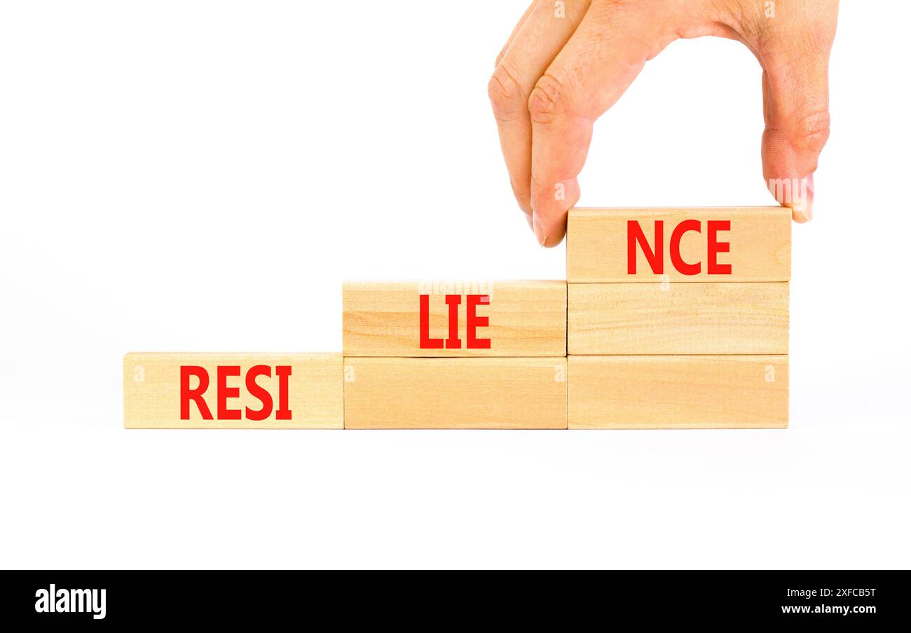 Resilience symbol. Concept word Resilience on beautiful wooden blocks. Businessman hand ...