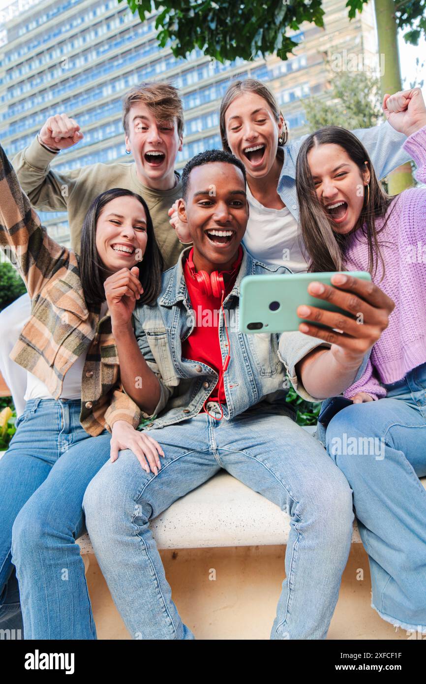 Happy successful cheering group multiethnic hi-res stock photography ...