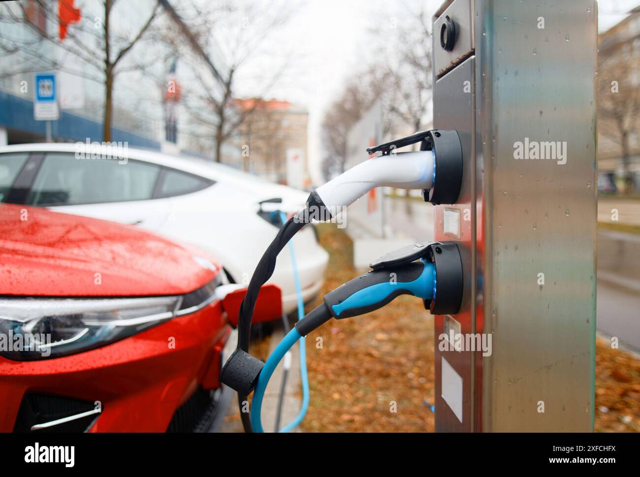 Electric car ev hybrid charging charger outdoors in a city Stock Photo ...