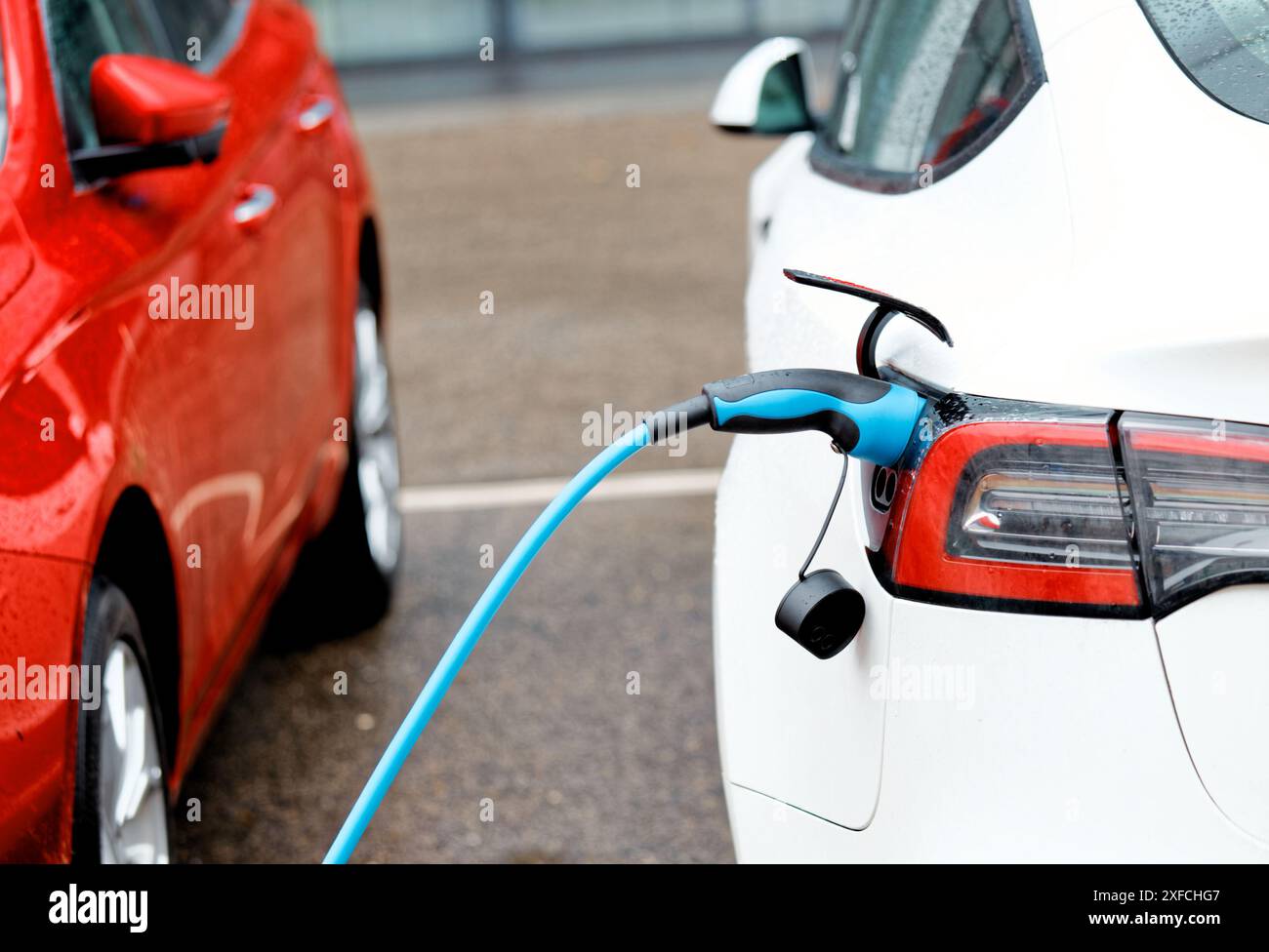 Electric car ev hybrid charging charger outdoors in a city Stock Photo ...