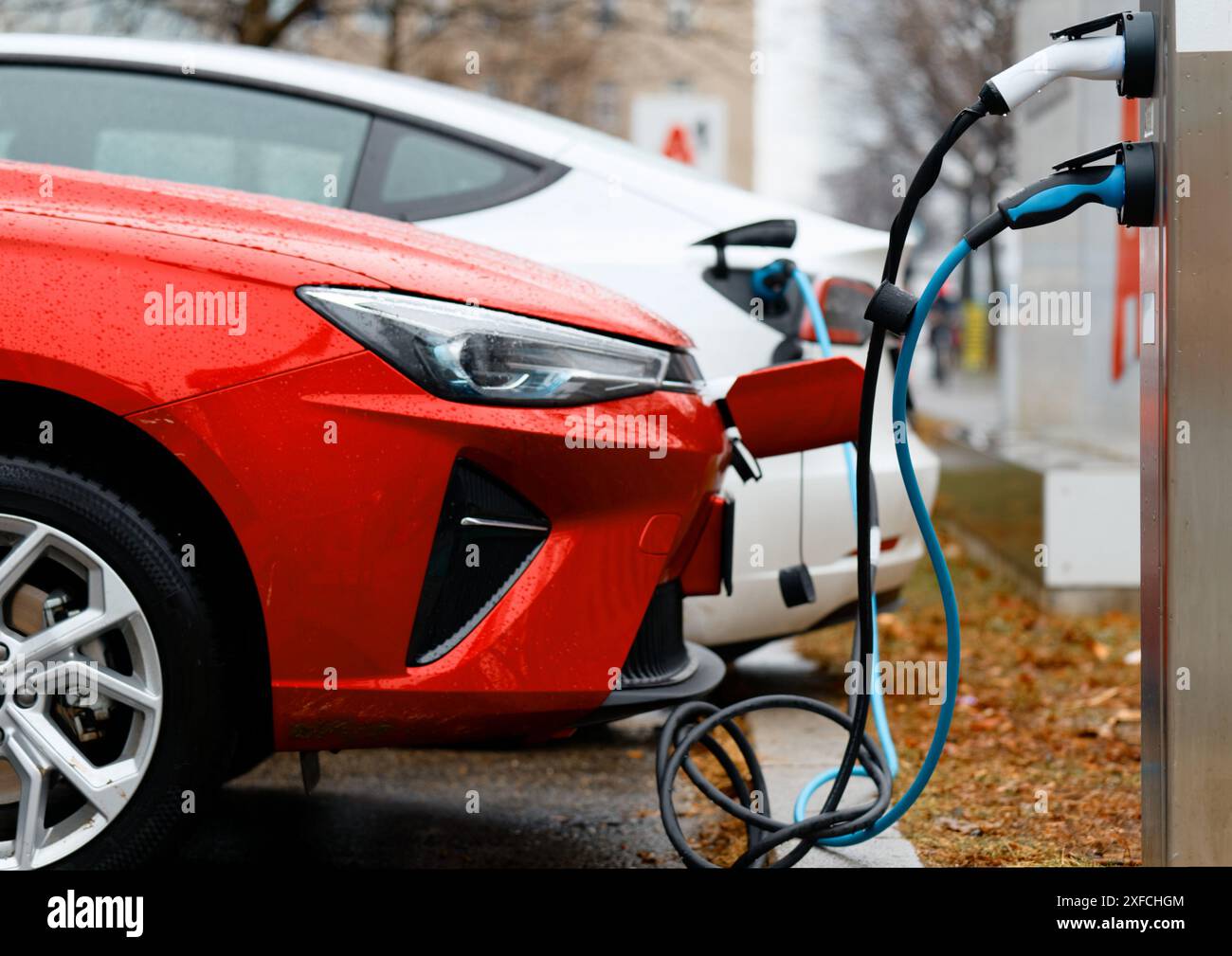 Electric car ev hybrid charging charger outdoors in a city Stock Photo ...