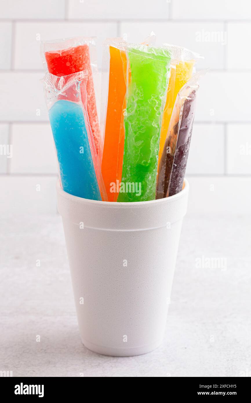 Rainbow Frozen Ice Popsicle on a Kitchen Counter Stock Photo - Alamy