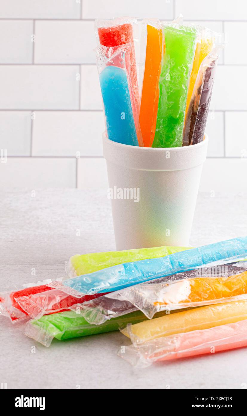 Rainbow Frozen Ice Popsicle on a Kitchen Counter Stock Photo - Alamy