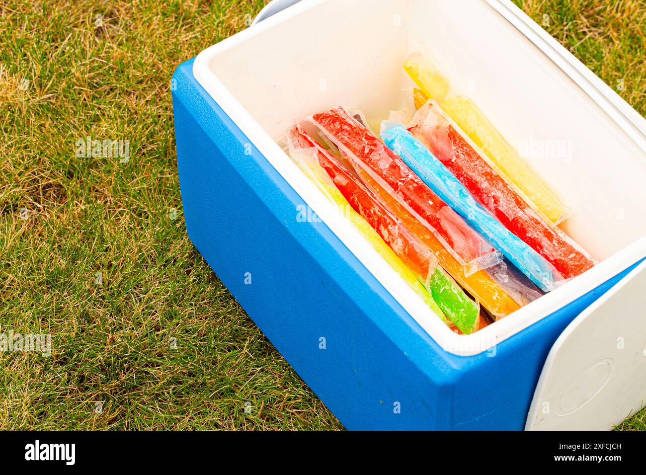 Frozen Ice Pop Popsciple in a Blue Cooler for a PIcnic Stock Photo - Alamy