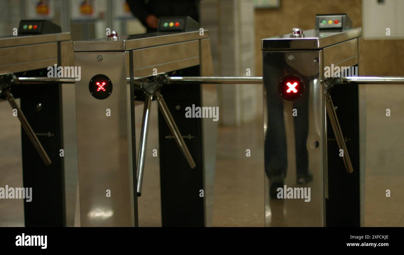 Turnstiles in the subway. People pass through the turnstiles. Check ...