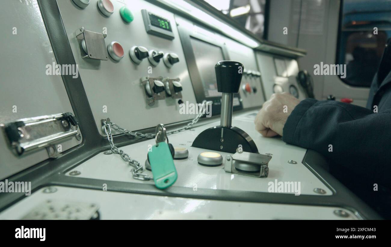 Train driver controls the subway. Checking the instrument panel Stock ...