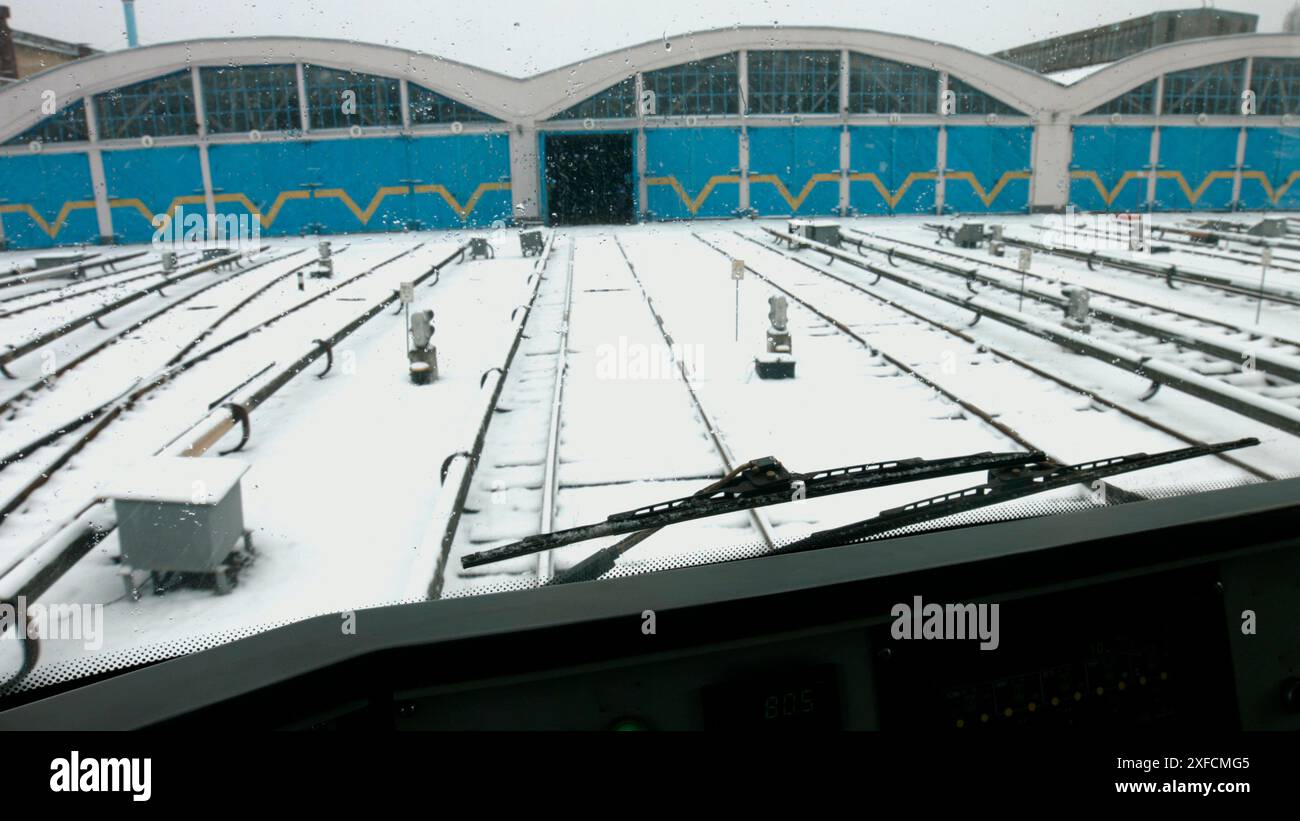 Metro train enters the depot through the gate. The train pulls in for ...