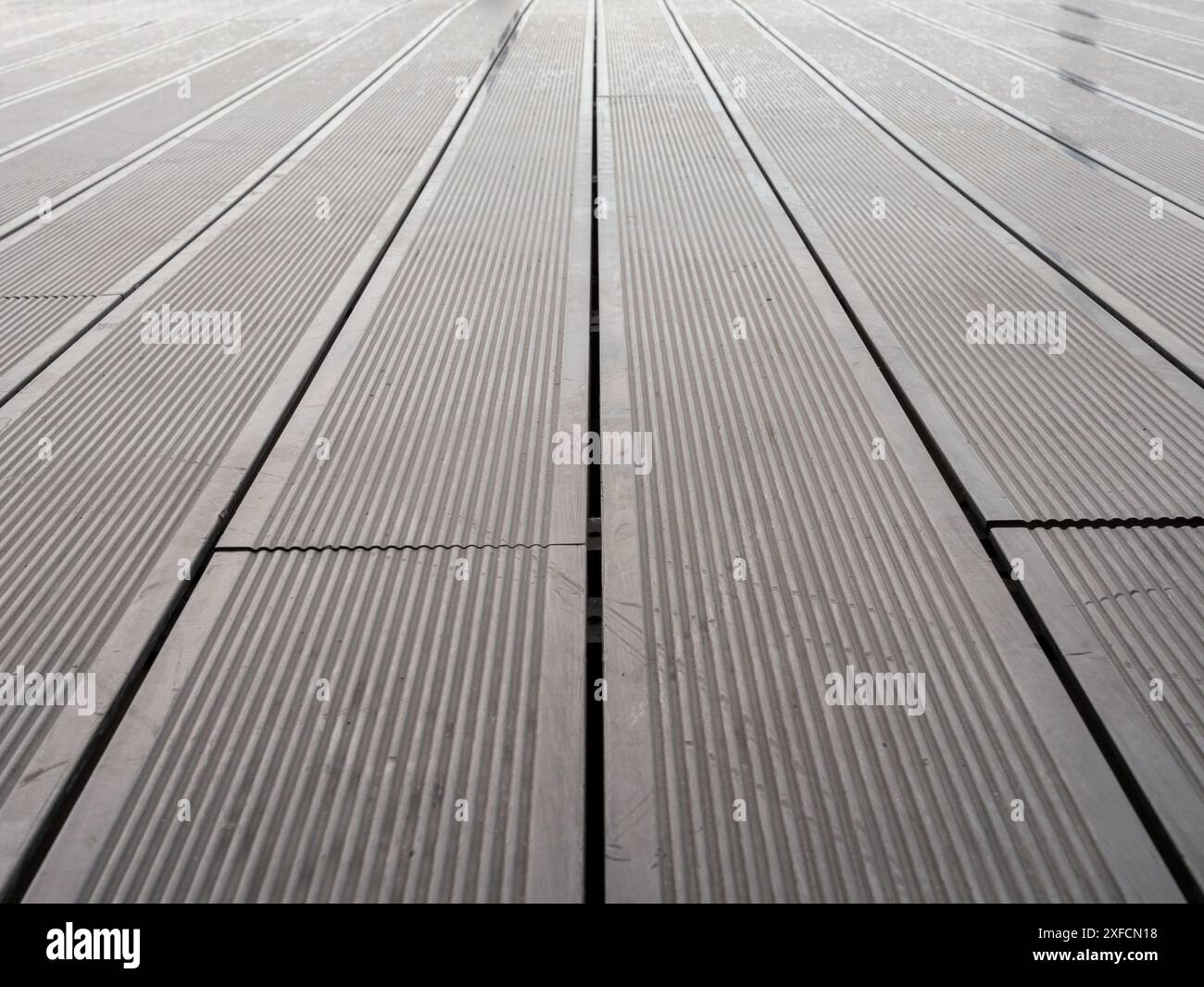 A close-up shot of wooden deck flooring, showcasing its grooved texture ...