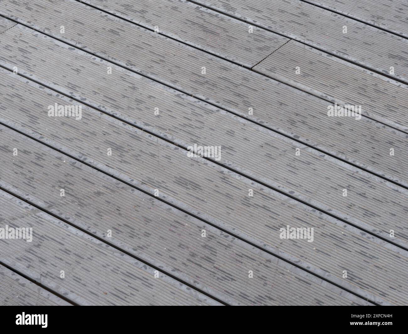 Wooden deck floor showing the wet, gray planks after a recent rainfall ...