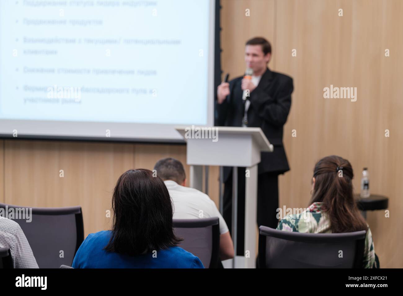Business professional giving a presentation during a tech conference ...