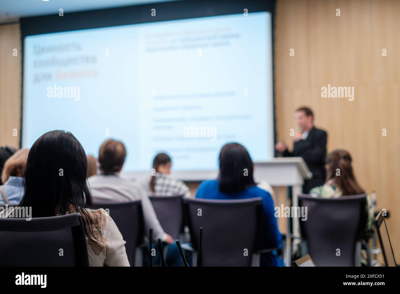 Speaker giving a presentation at a tech conference, engaging an ...