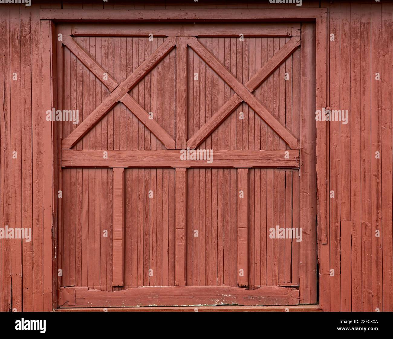 Red barn door with top-hinged, double sliding access door Stock Photo ...