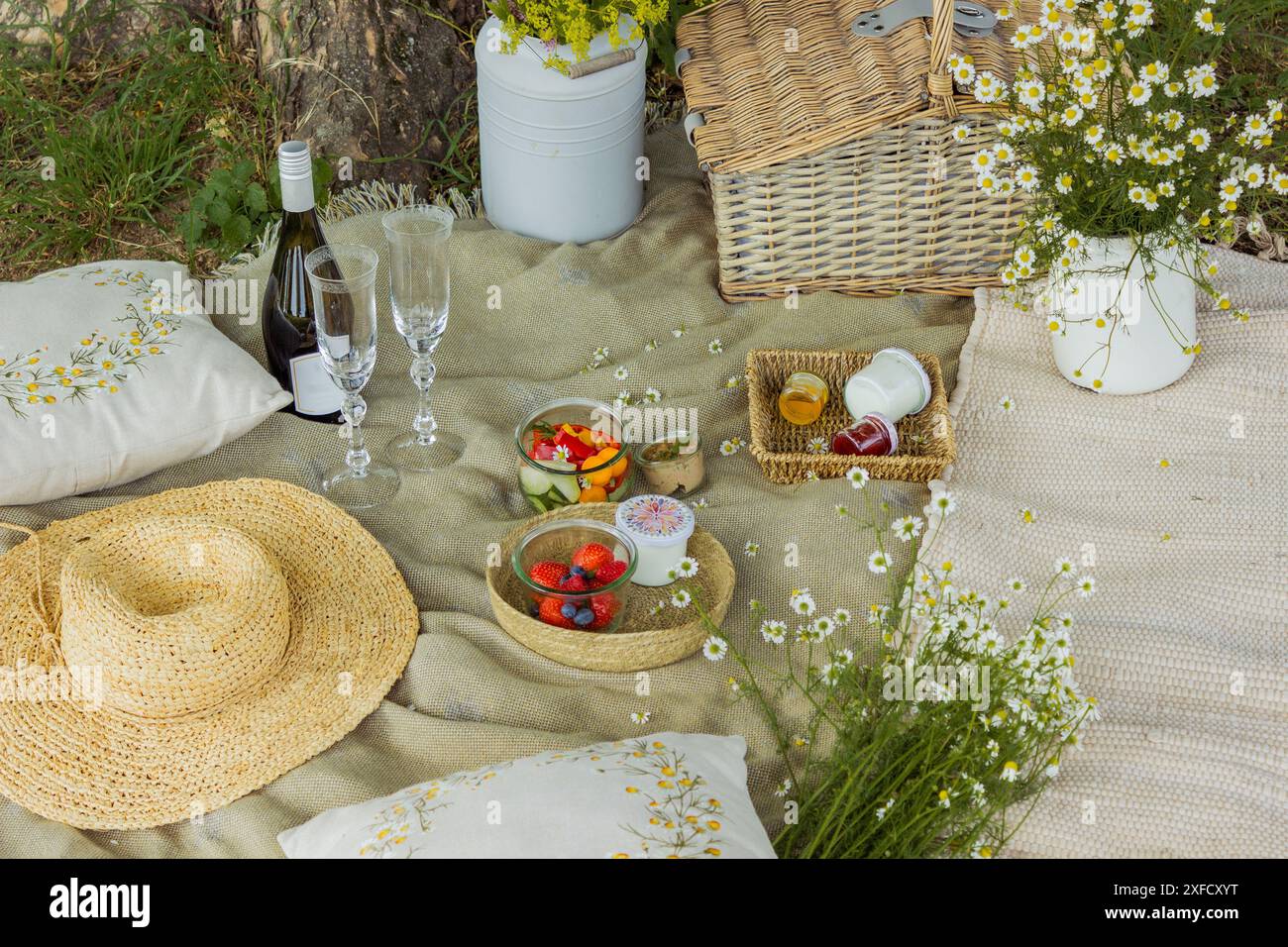 Beautiful white boho style decor. Picnic in nature on the grass under ...