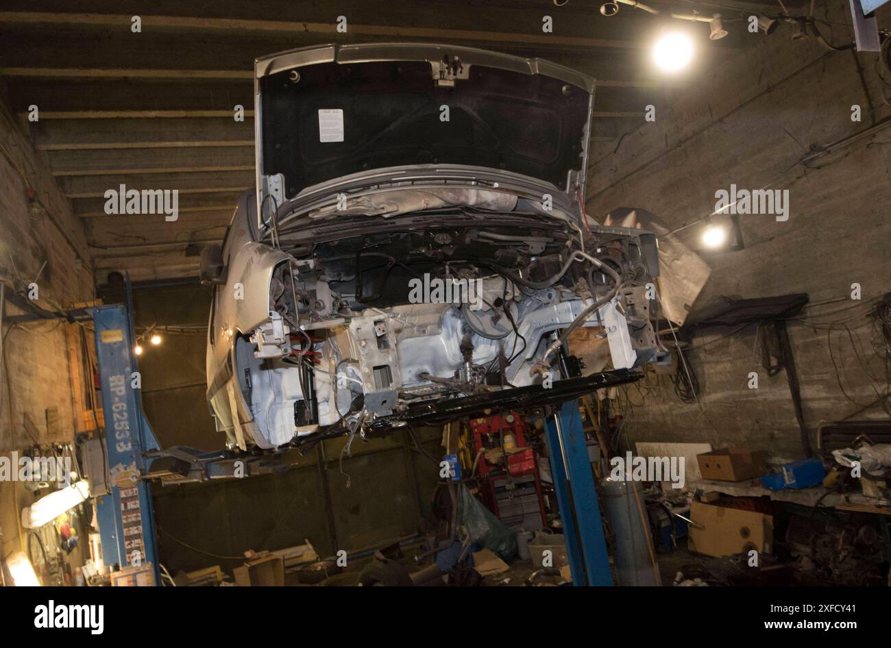 automotive mechanic works on the car to fix a problem automotive ...