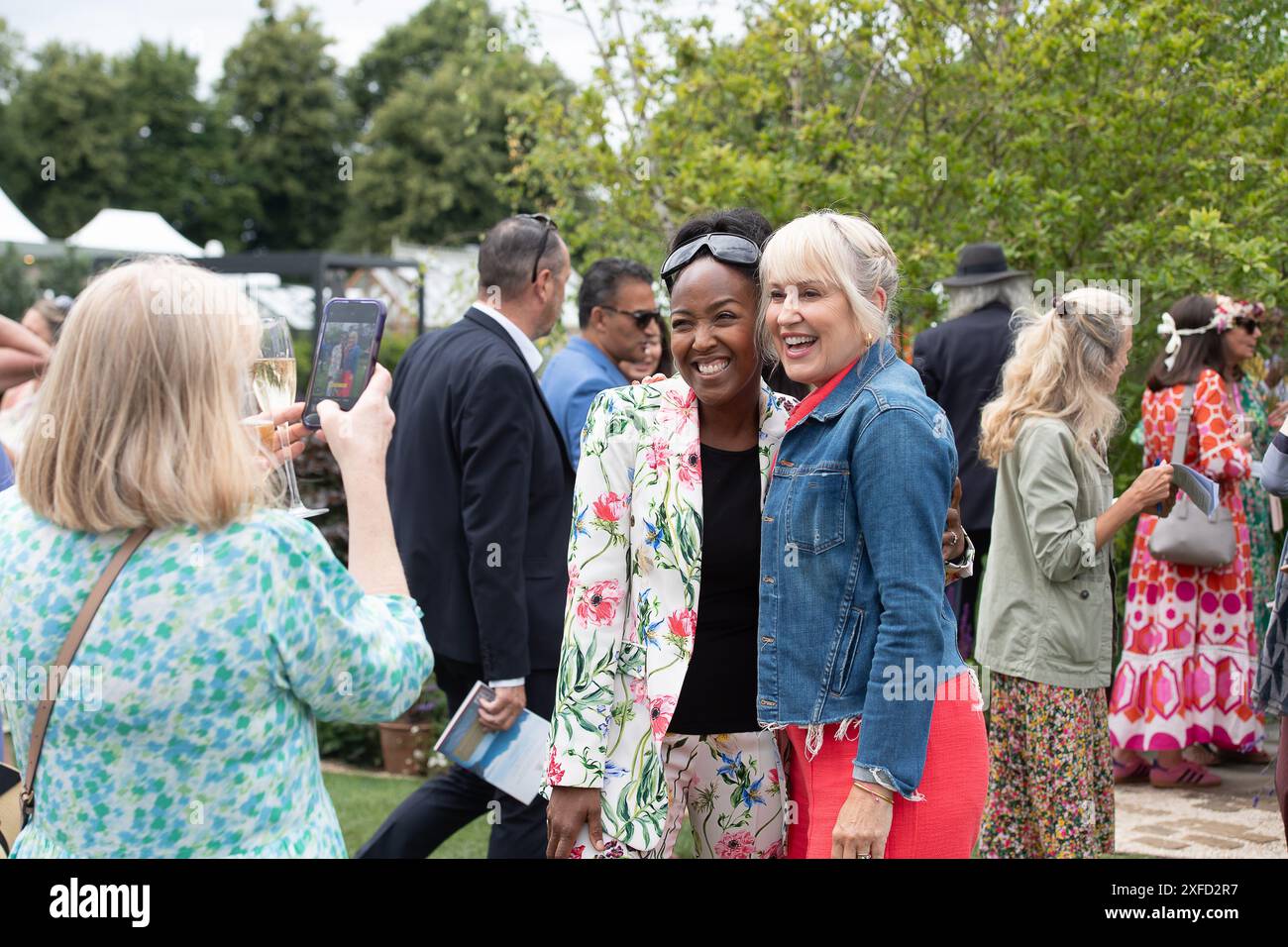 East Molesey, UK. 1st July, 2024. A lady takes a photo of television ...