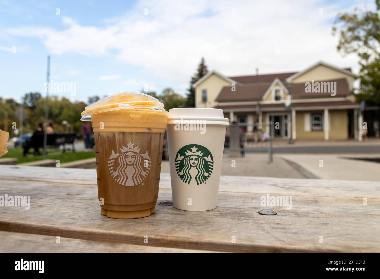 Two Starbucks drinks in sunlight - outdoor wooden table - iced with ...