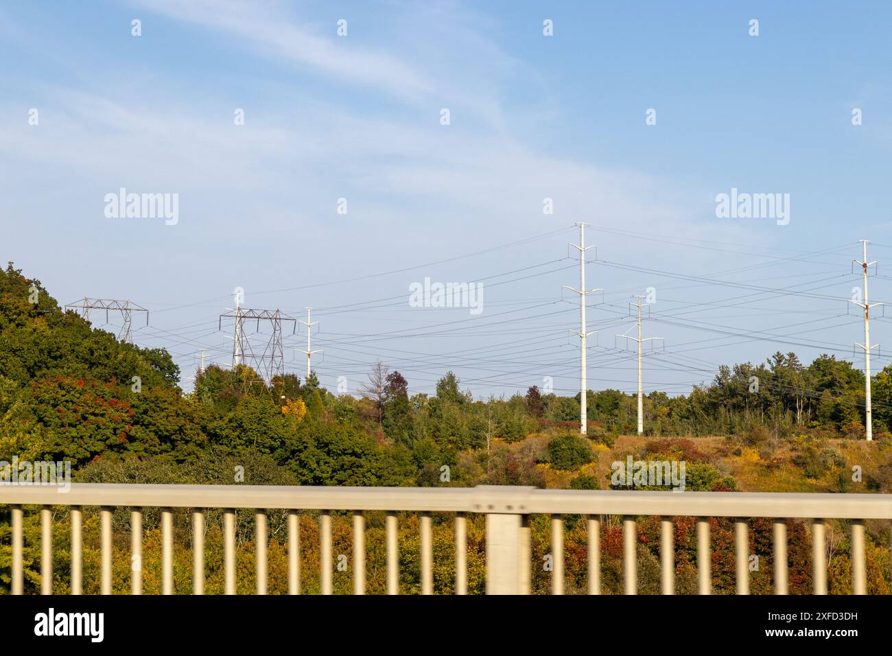 Bright autumn foliage under a clear blue sky - power lines and ...