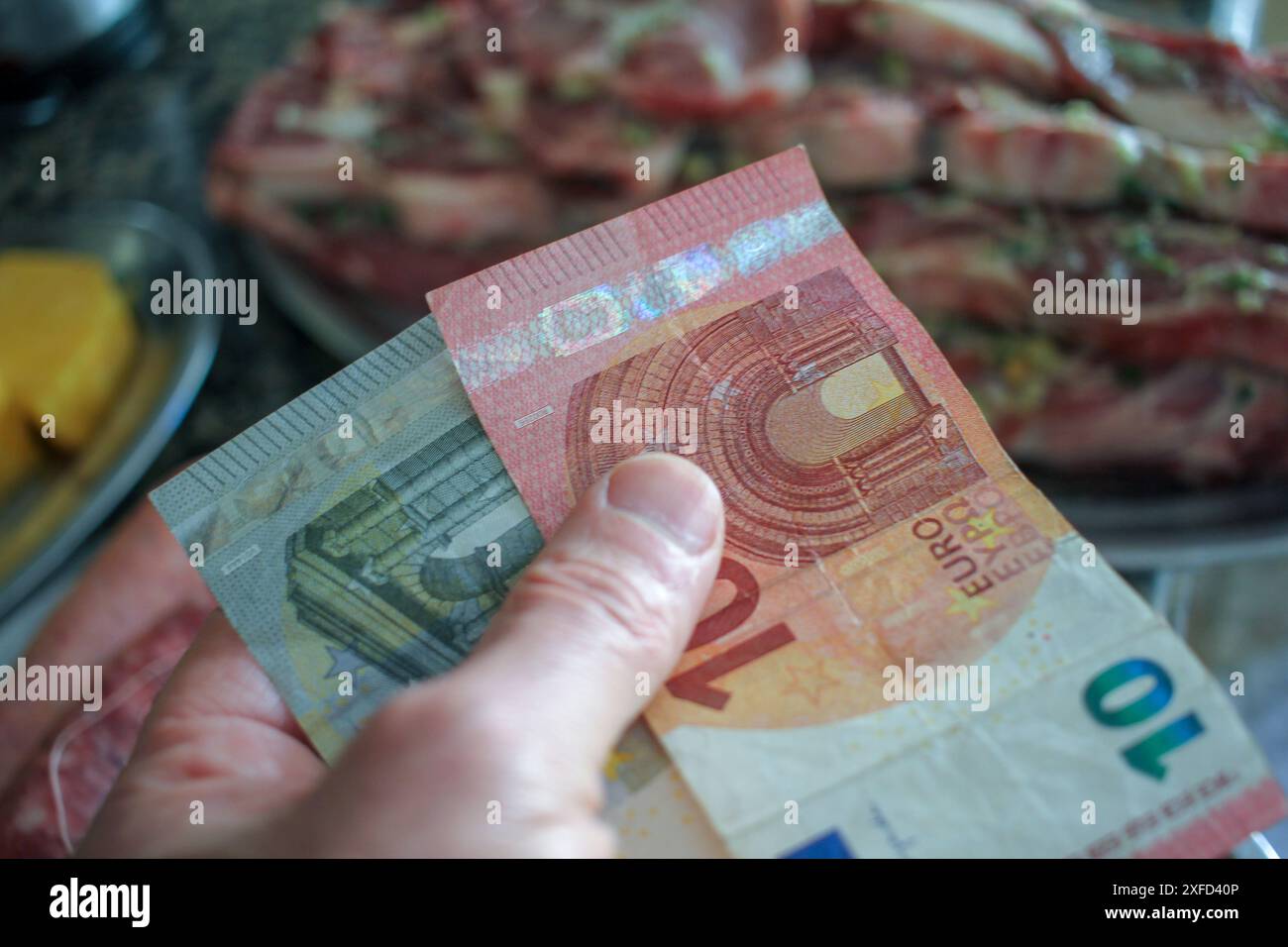 euro bills and meat, concept, the rising prices of food Stock Photo - Alamy