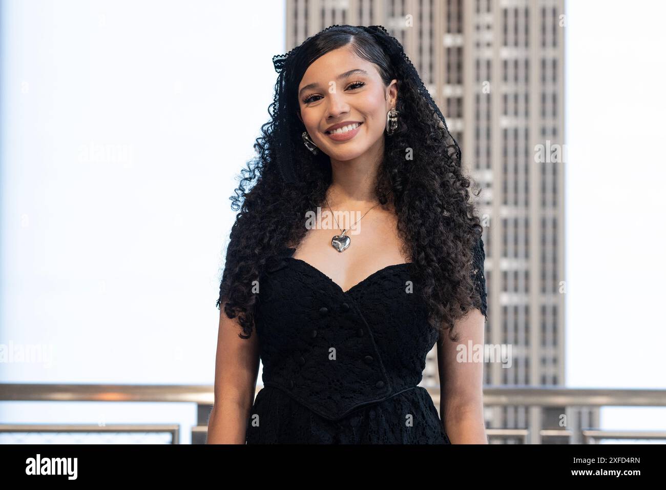 Malia Baker wearing dress by Betsy Johnson visits Empire State Building ...