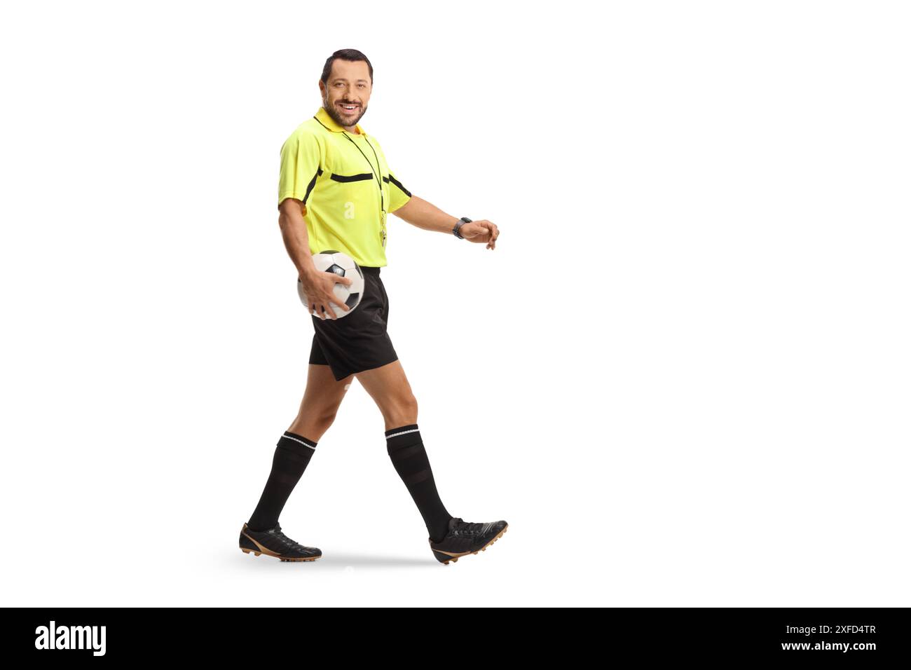Football referee carrying a ball and walking isolated on white ...