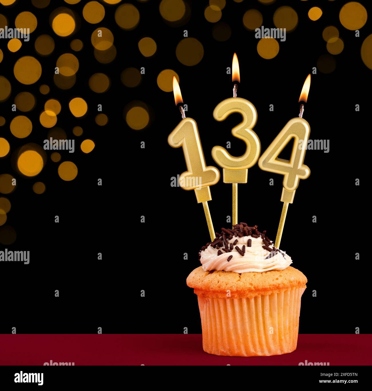 Birthday candle with cupcake - Number 134 on black background with out ...