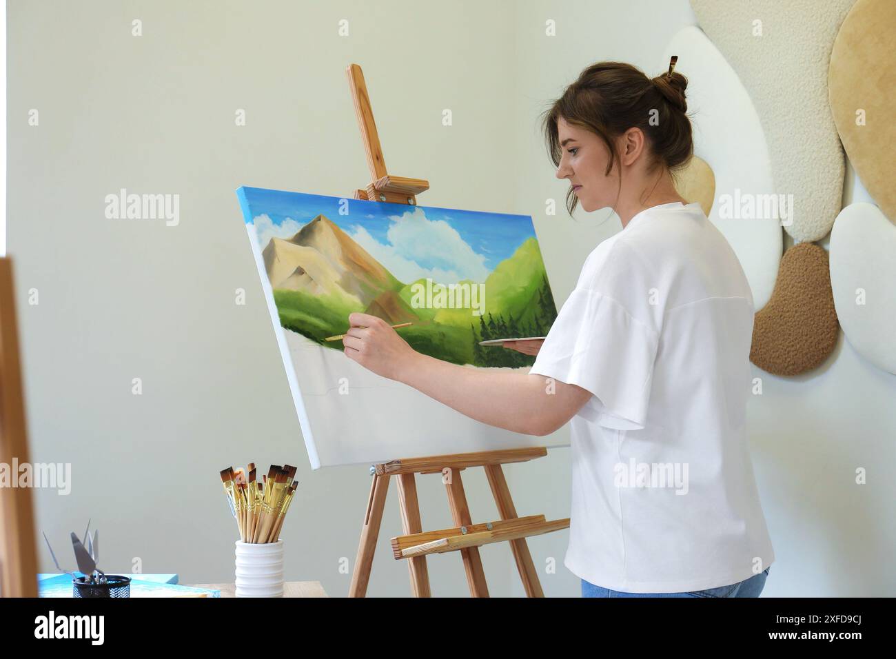 Woman drawing landscape with brush in studio Stock Photo - Alamy
