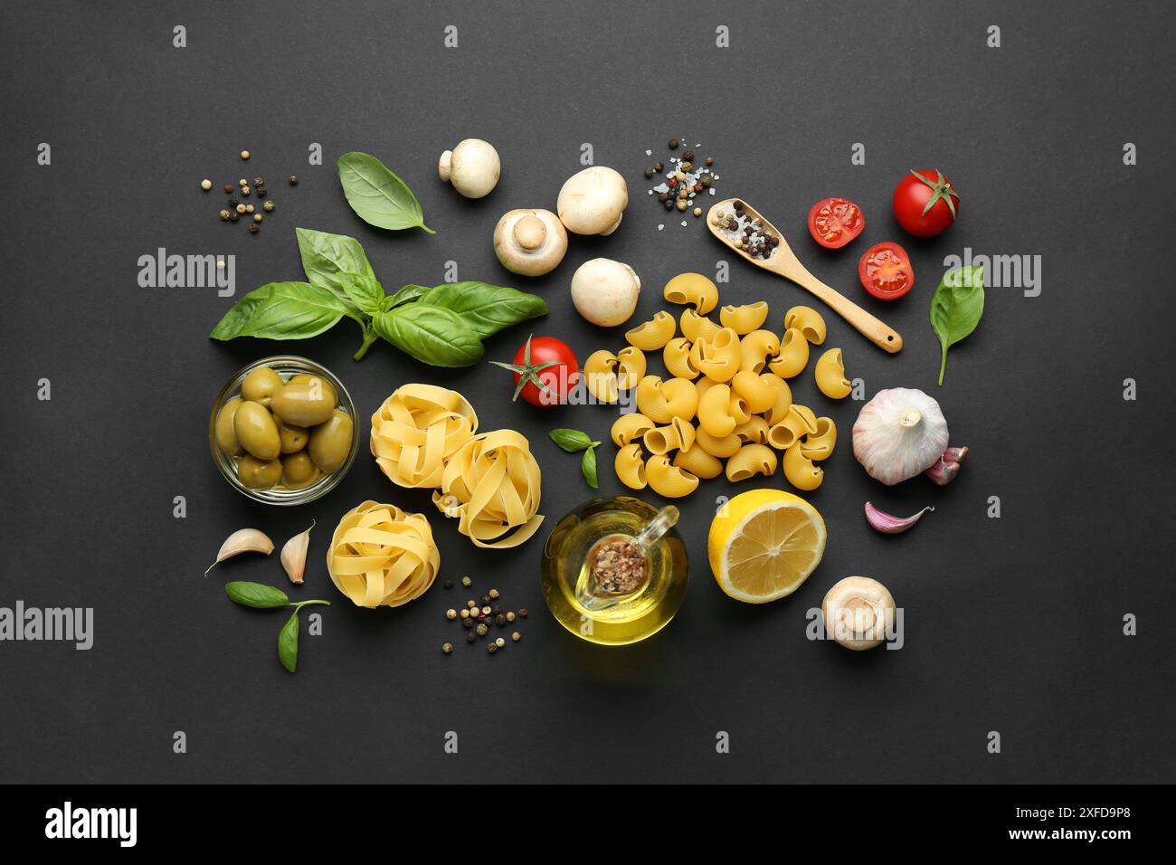 Different types of pasta, spices and products on black background, flat ...