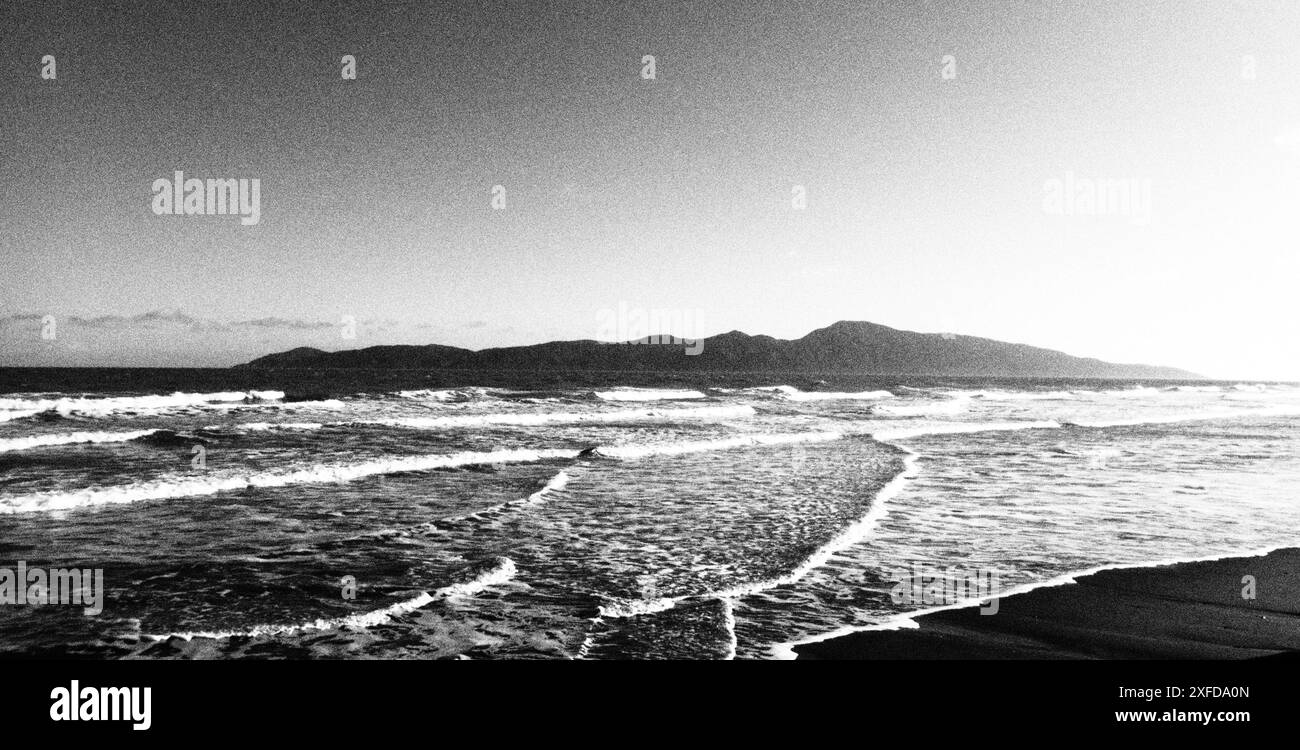 Kapiti Island (NZ) and low rippling surf with a bit of beach. Island is ...