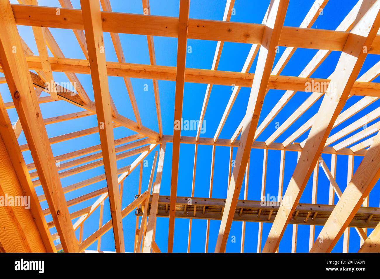 Home under construction with timber trusses framed construction roofing ...