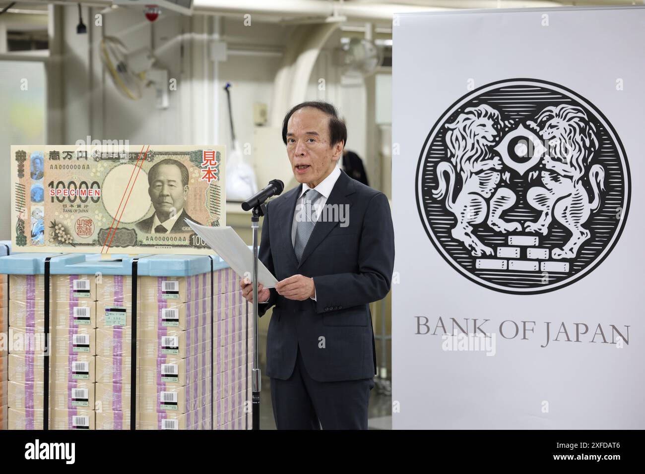 Bank of Japan's governor Kazuo Ueda delivers a speech as new banknotes ...