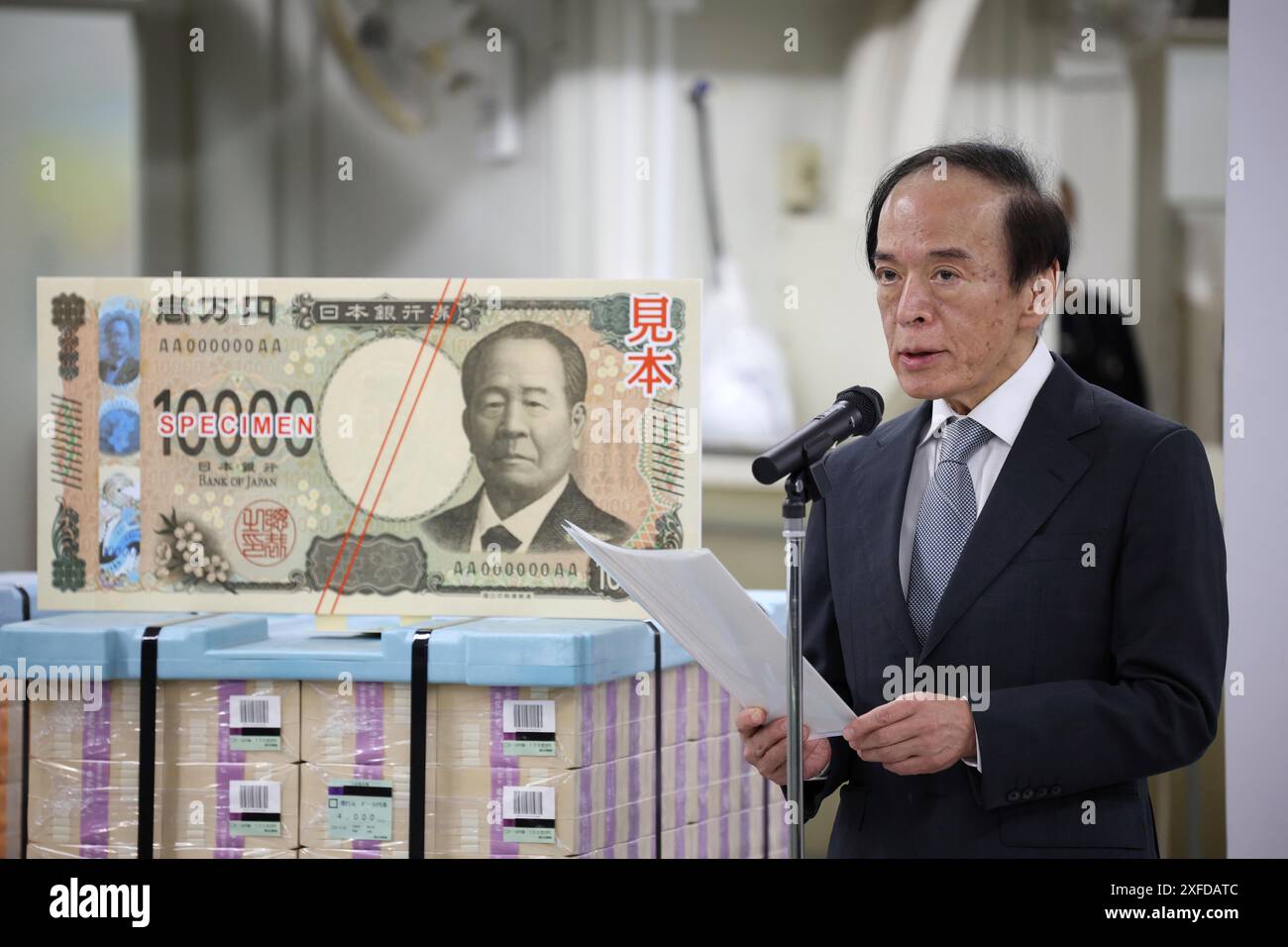 Bank of Japan's governor Kazuo Ueda delivers a speech as new banknotes ...