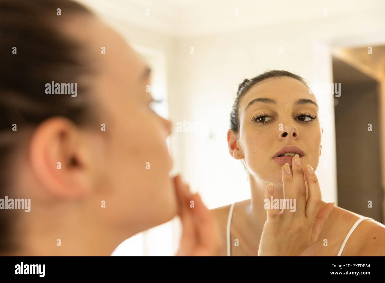 Woman applying foundation in mirror hi-res stock photography and images - Alamy