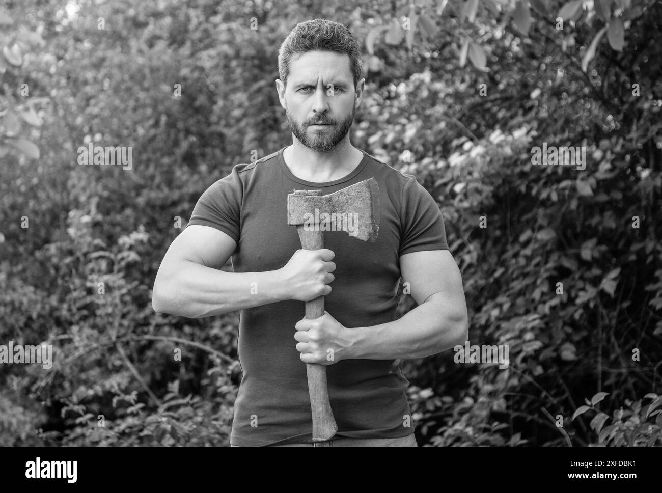 photo of man hold ax. man with ax. man with ax wearing shirt. man with ...