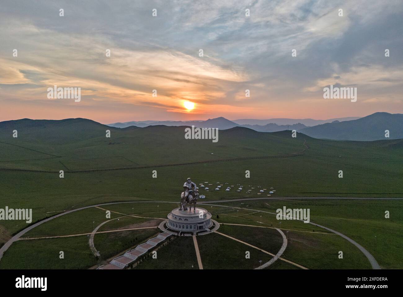 The sun sets over a 40-meter- (130-foot-) tall stainless steel statue ...